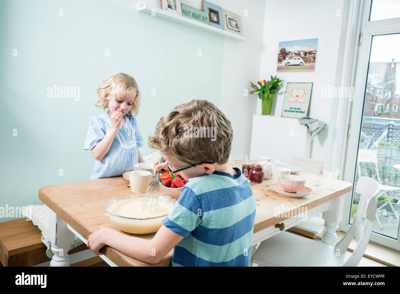 Brother and sister in kitchen cooking together Stock Photo - Alamy