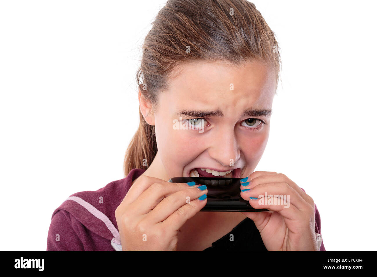 desperate young woman bites in her smart phone, isolated on white Stock ...