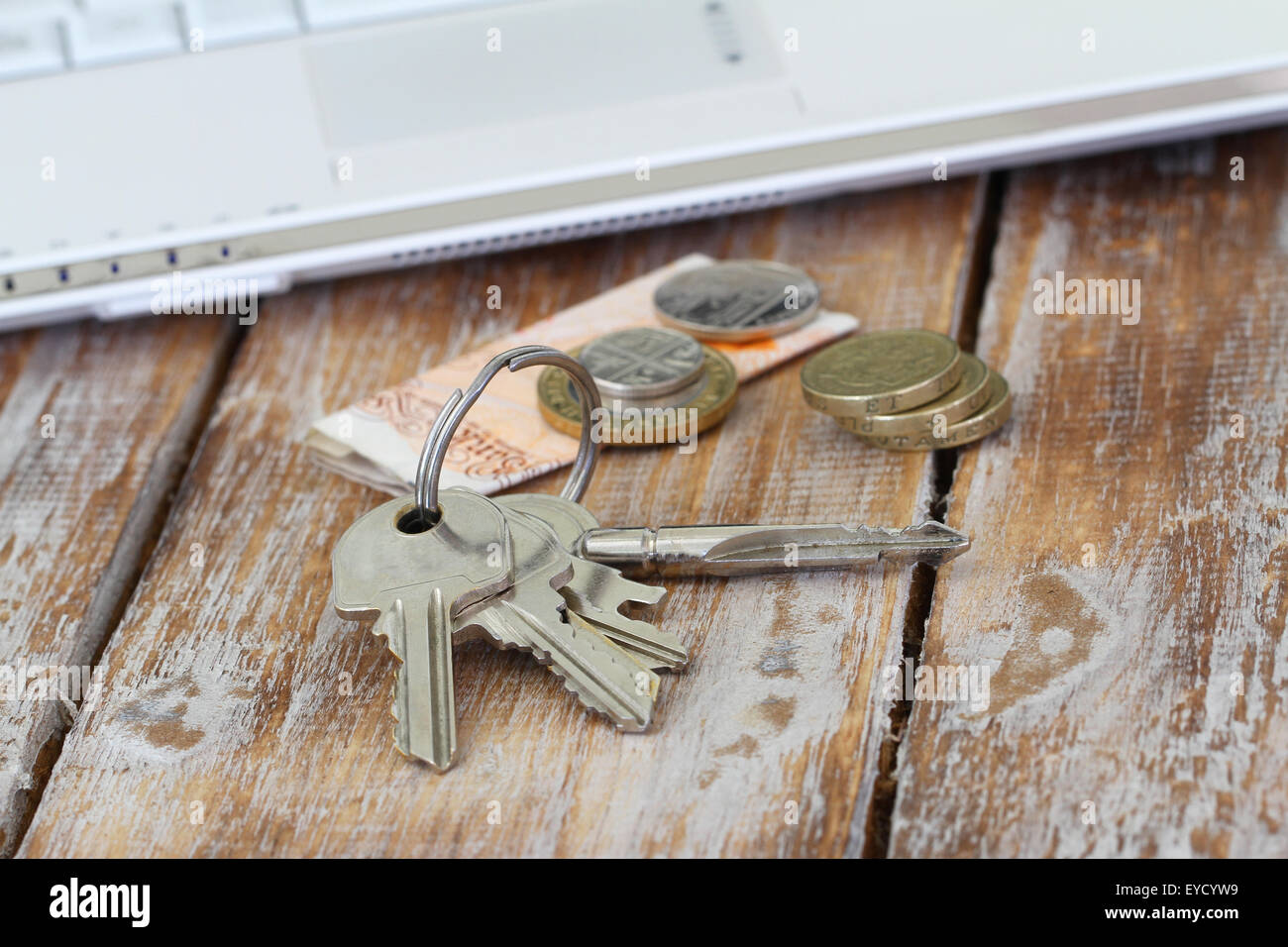 Bunch of keys on rustic surface and some change in British pounds Stock ...