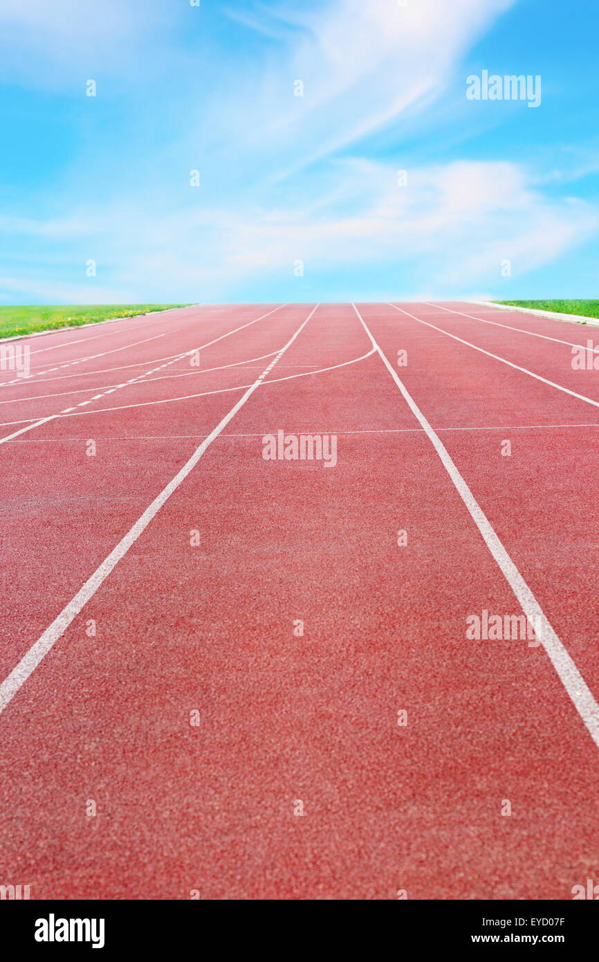 detail of a running track towards the horizon and blue sky Stock Photo ...