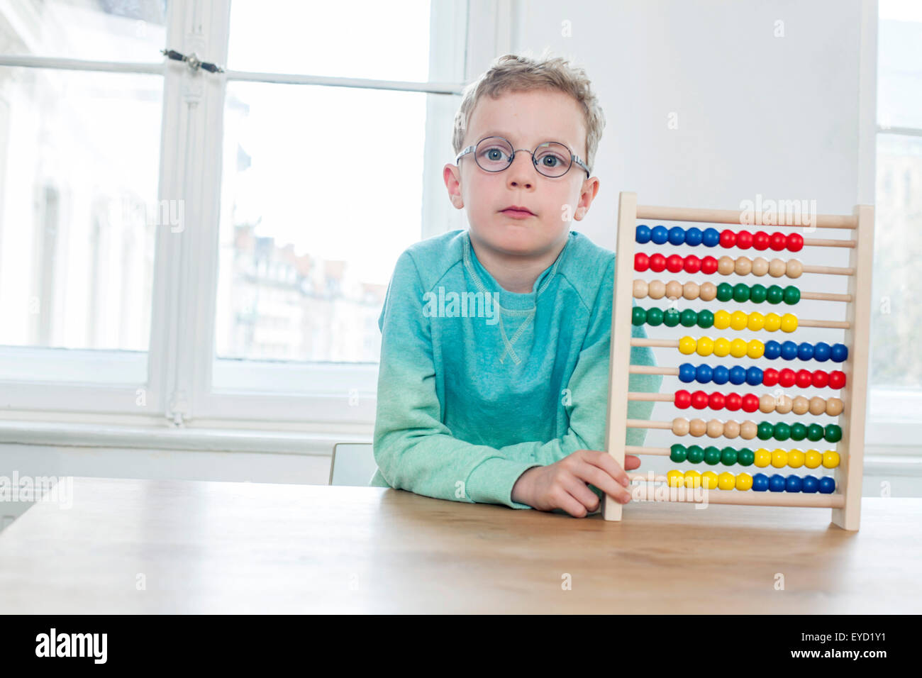 Boy calculating with abacus Stock Photo - Alamy