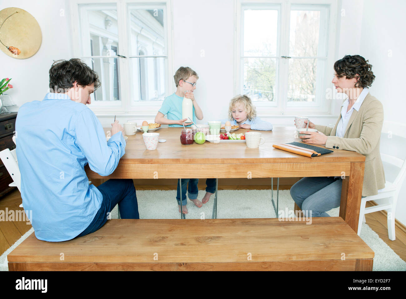 Family at breakfast table in kitchen Stock Photo - Alamy