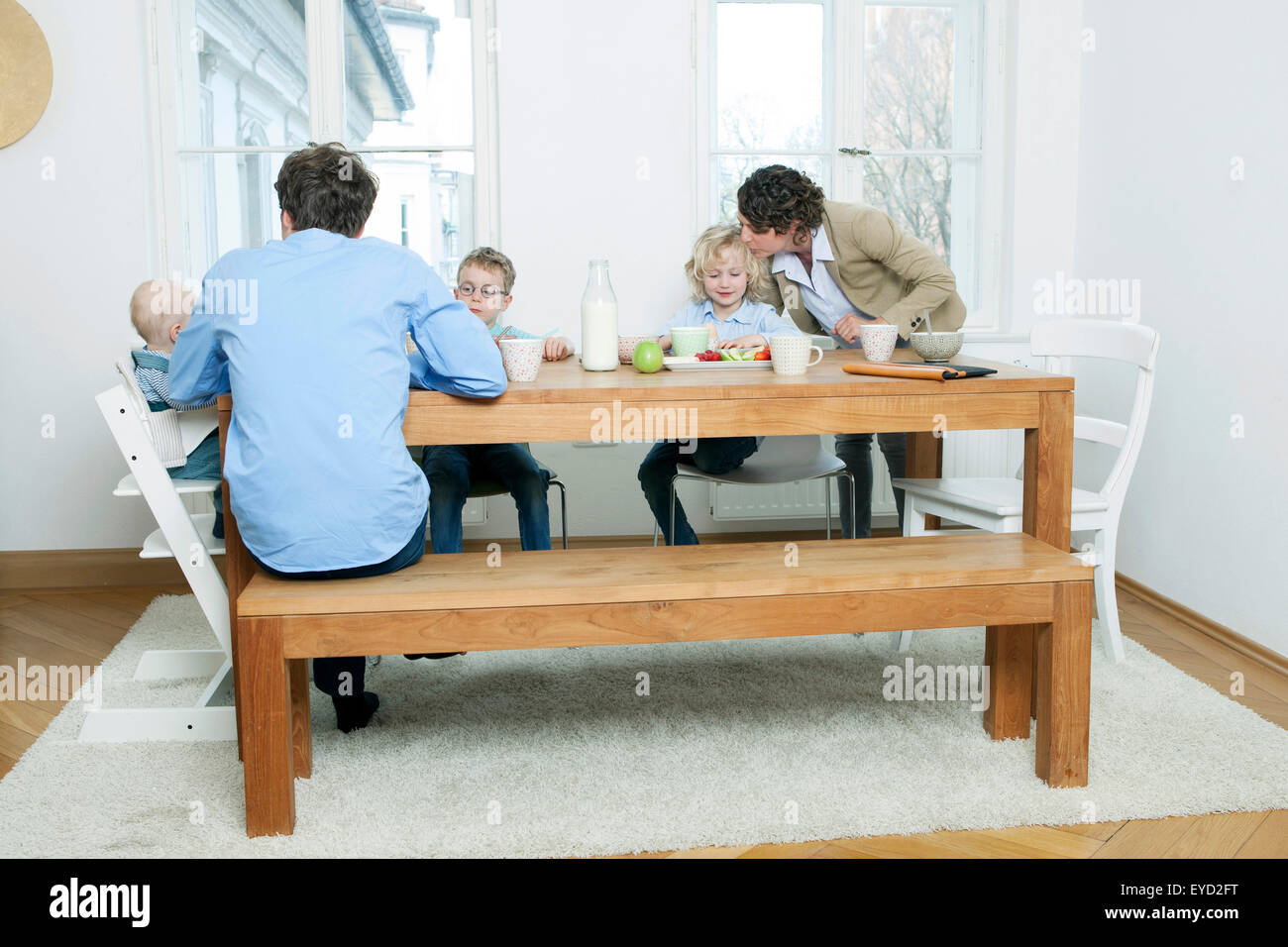 Family at breakfast table in kitchen Stock Photo - Alamy