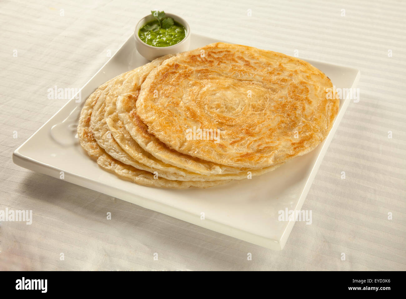 Plain paratha puri served with freshly diced corriander in green ...