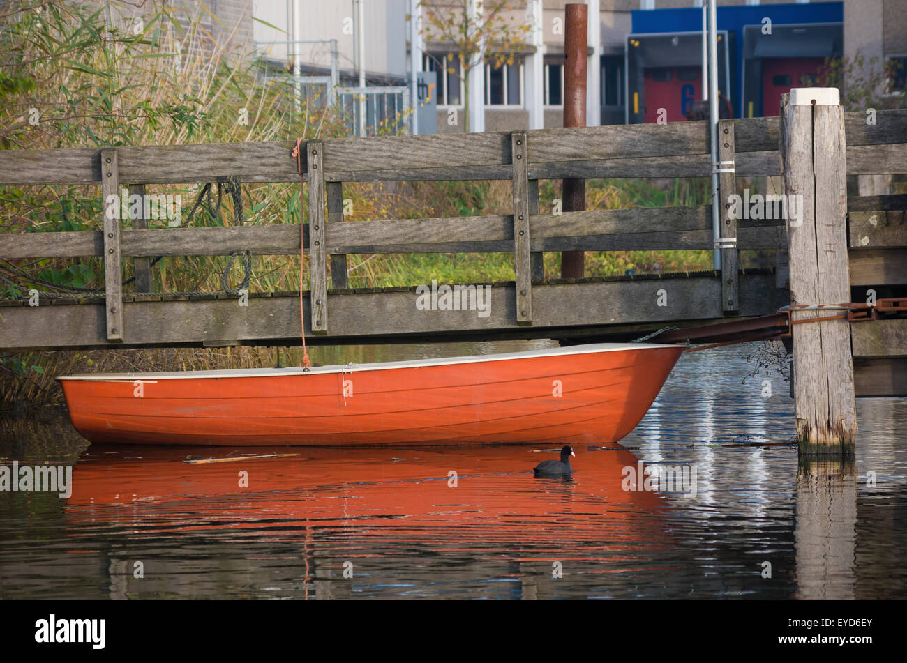 red rowing boat moored at a pier Stock Photo - Alamy