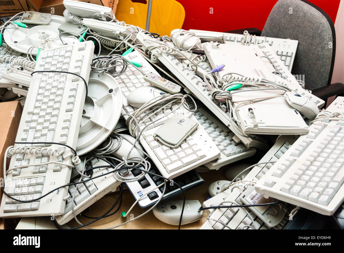 Junked computers stored in room. Piles of stacked white obsolete ...