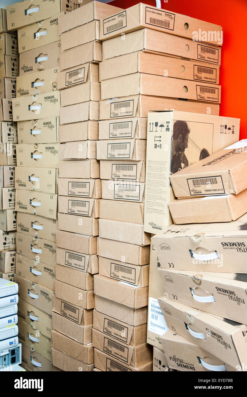 Junked computers stored in room. Stacked cardboard computer base boxes ...