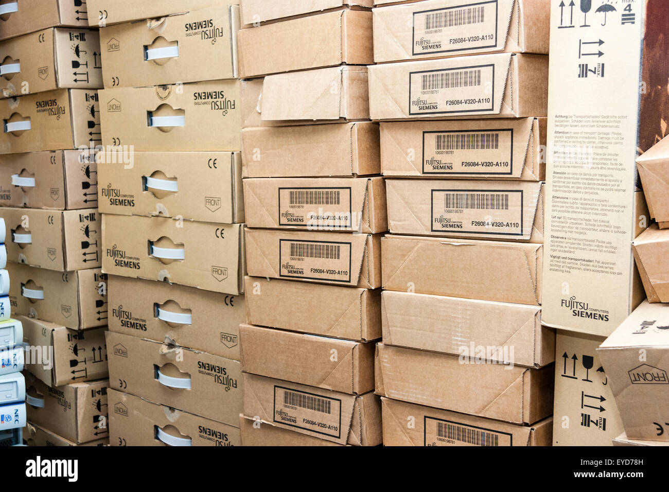 Junked computers stored in room. Stacked cardboard computer base boxes ...