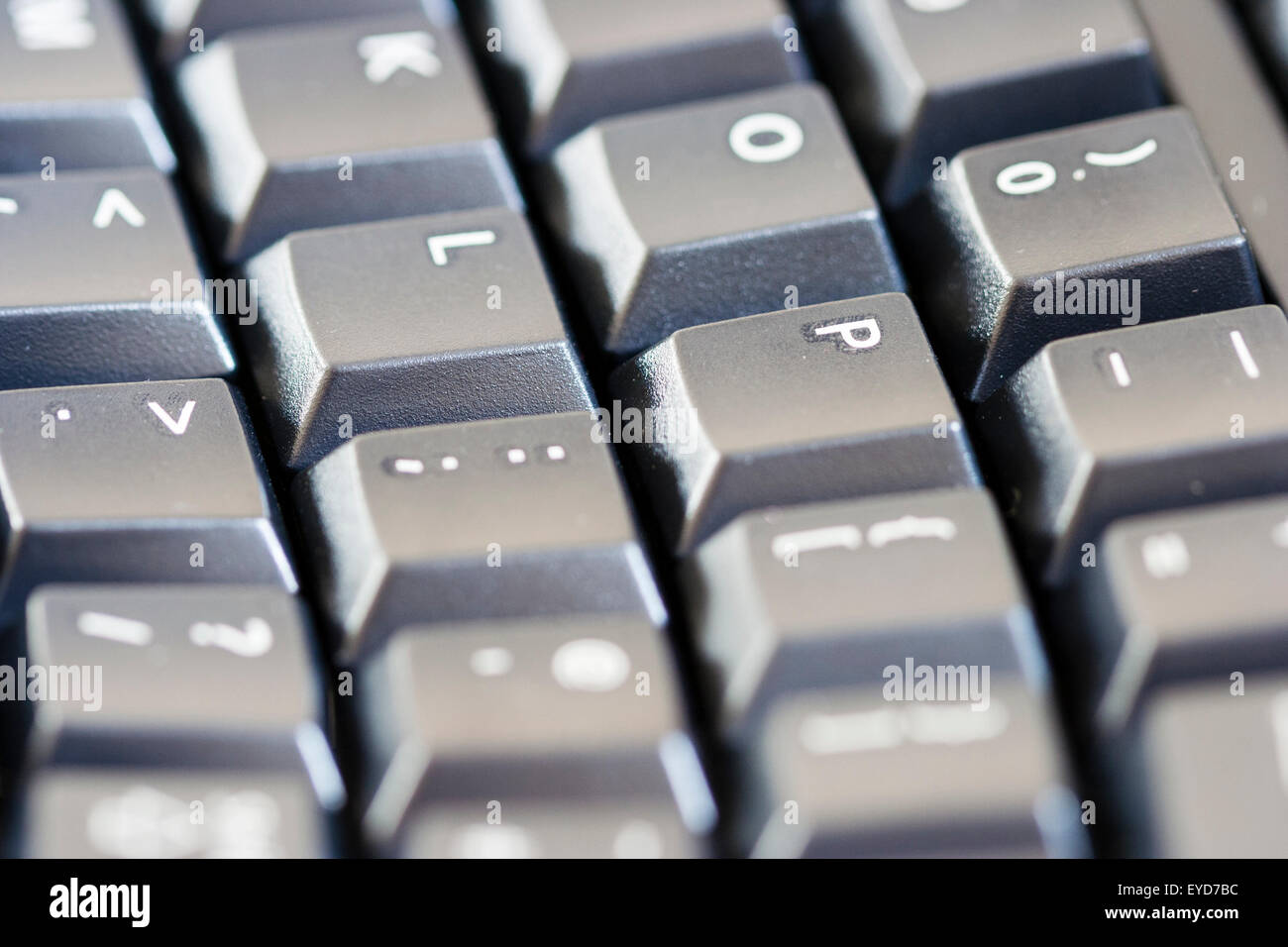 View along dark grey computer keyboard input device. Showing various ...