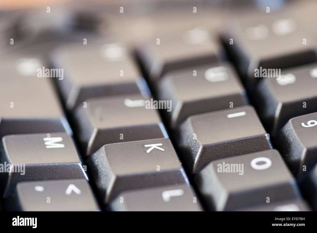 View along dark grey computer keyboard input device. Showing various ...