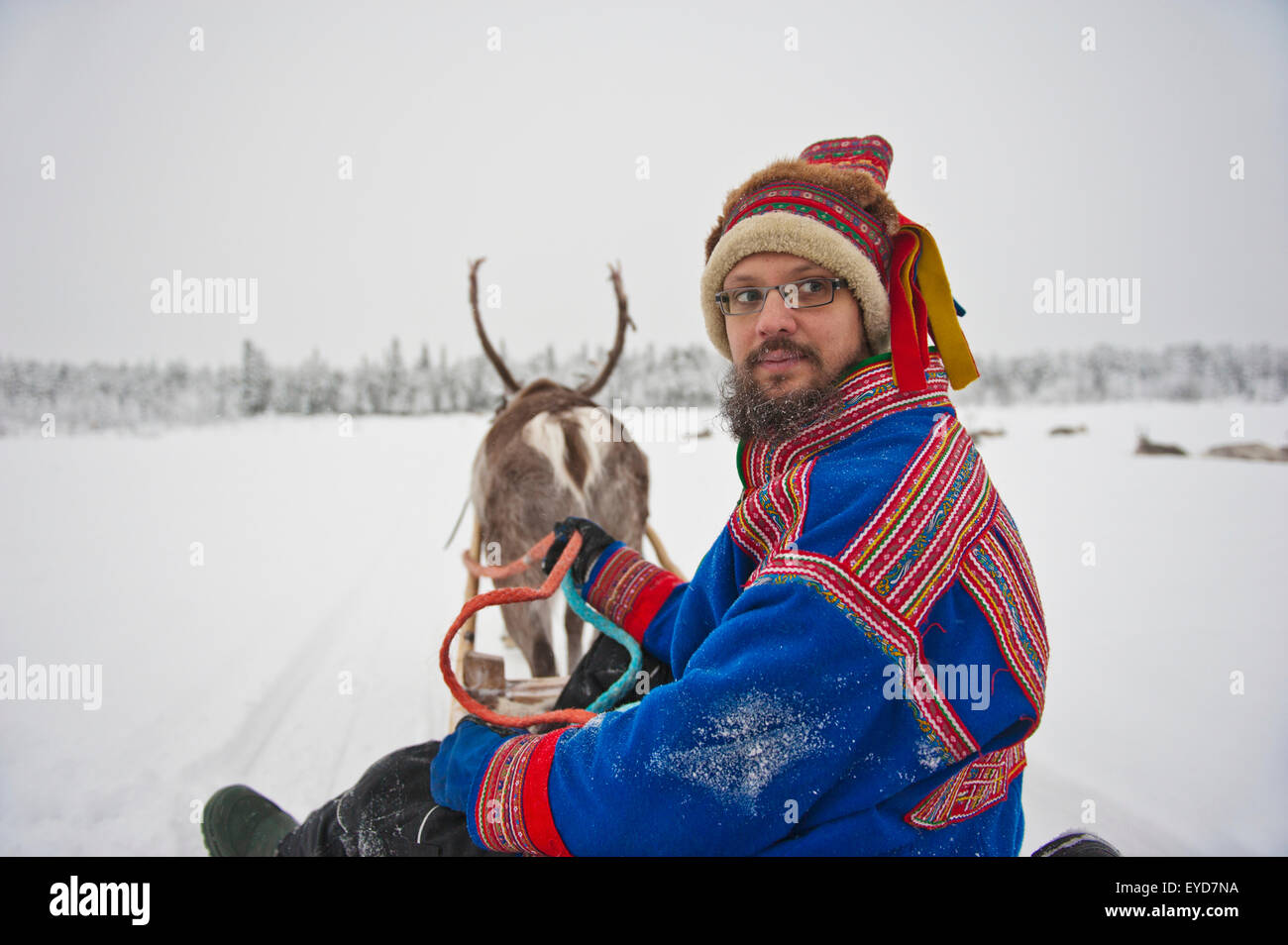 A Herder Wearing The Traditional Sami Clothing With Reindeer At ...
