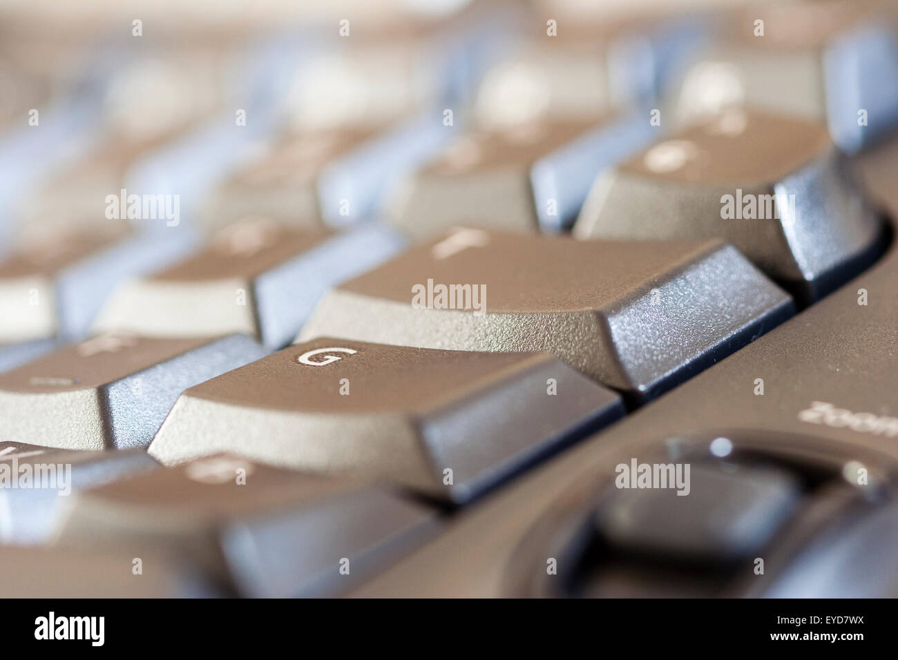 View along dark grey computer keyboard input device. Showing various ...