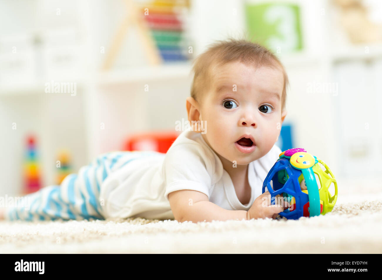 baby playing on a carpet at home Stock Photo - Alamy