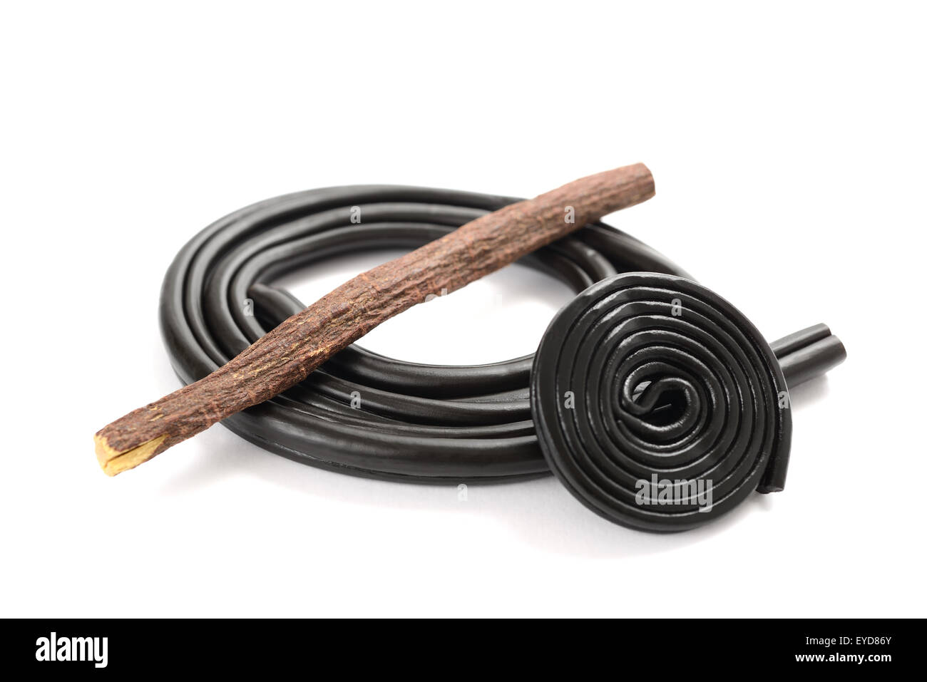 Licorice roots and licorice black on white background Stock Photo - Alamy