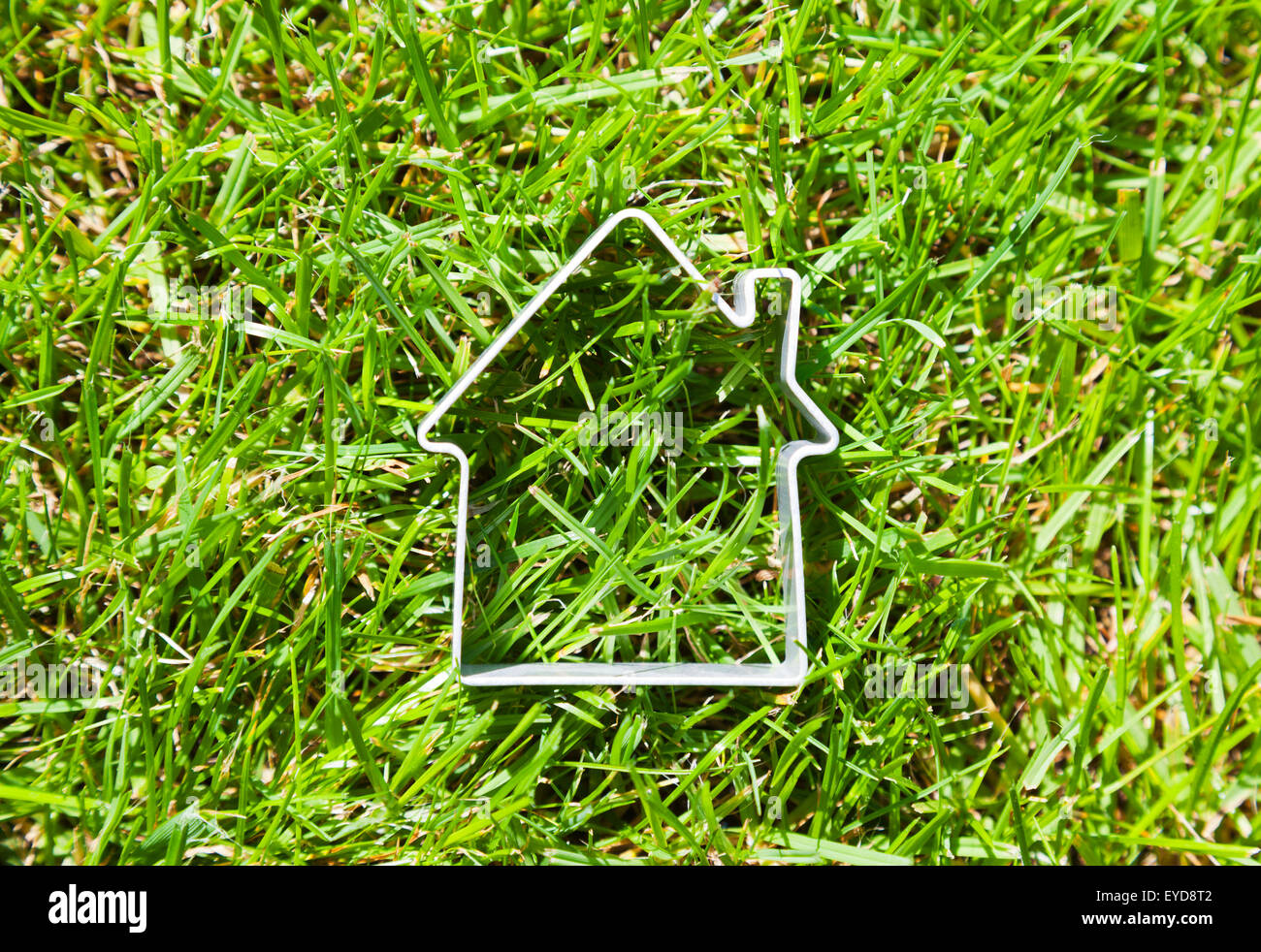 House shape over green grass Stock Photo - Alamy