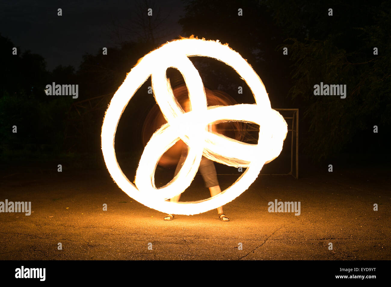 Fire-show man in action in night time Stock Photo - Alamy