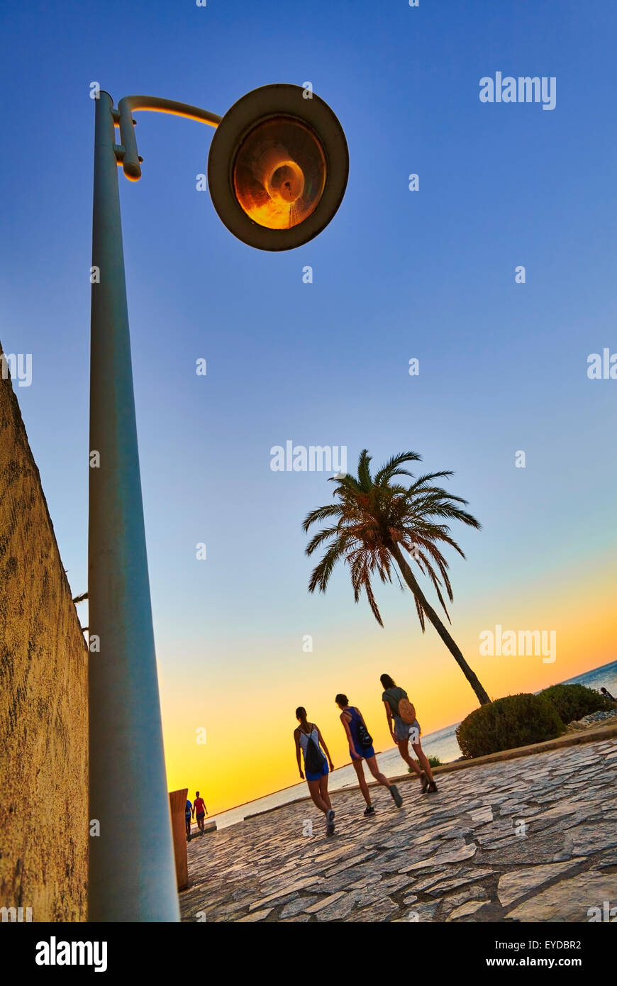 People walking by the seafront promenade at "Las Rotas" beach. Denia ...
