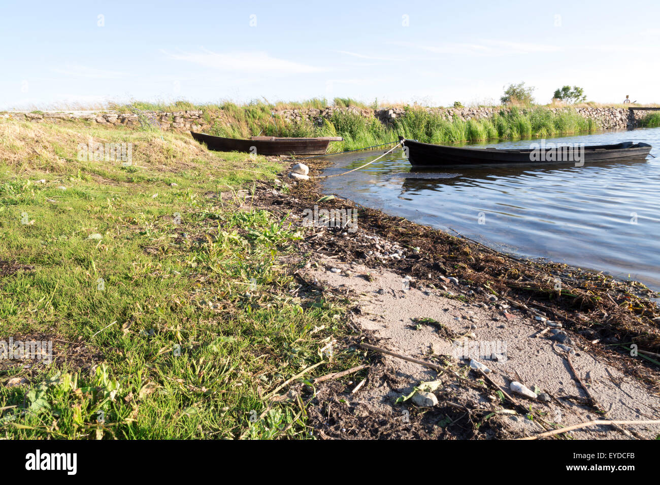 Pair of Rowing Boats in water on beach Stock Photo - Alamy