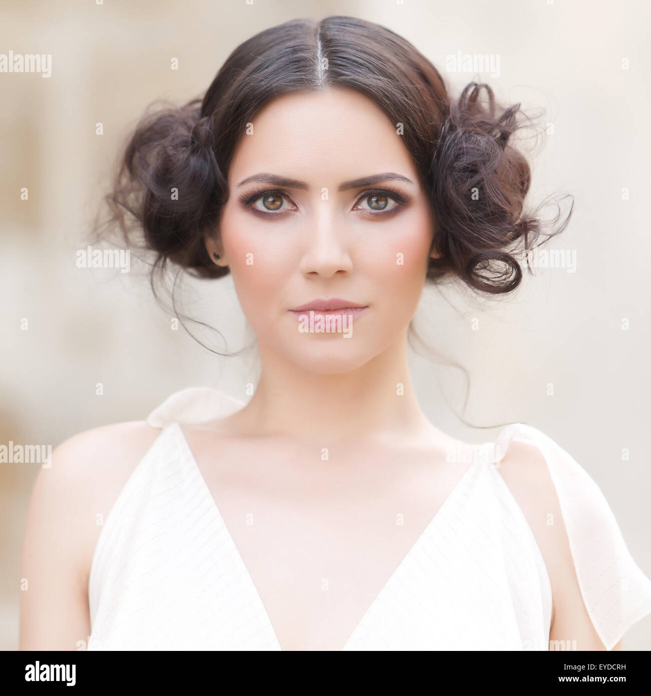 Refined woman with unusual hairstyle and elegant pose looking with very ...