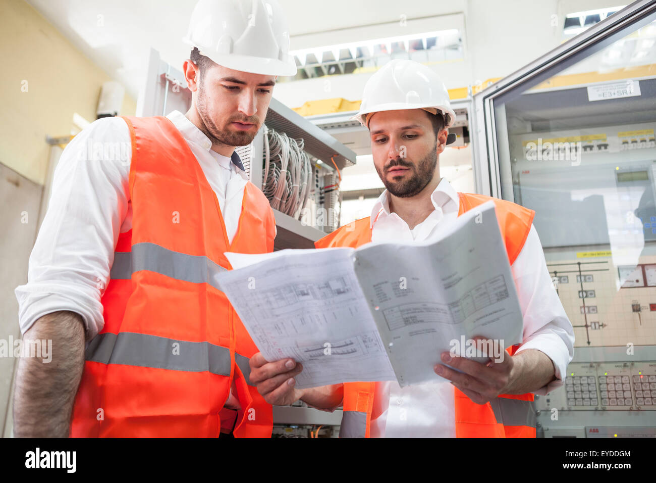 Two engineers checking electricity substation Stock Photo - Alamy