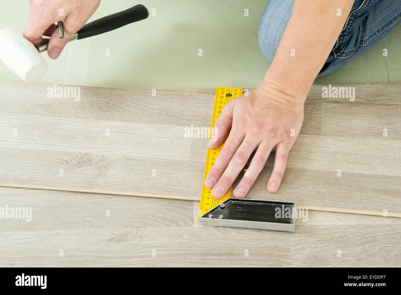 Man with Tools to Laying Laminate Stock Photo - Alamy