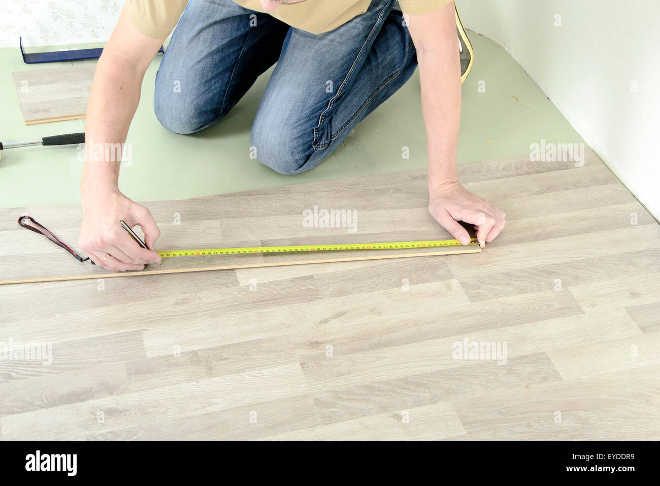Man with Tools to Laying Laminate Stock Photo - Alamy