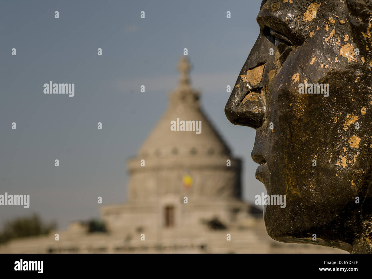 War memorial in Romania Bronze statue in foreground with historic dome ...