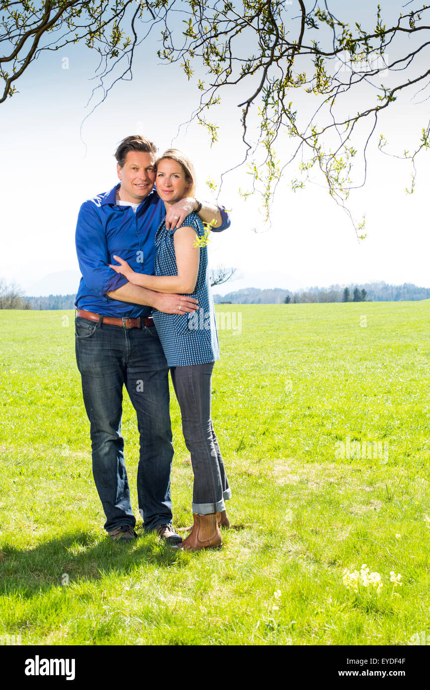 Happy couple embracing in meadow Stock Photo - Alamy