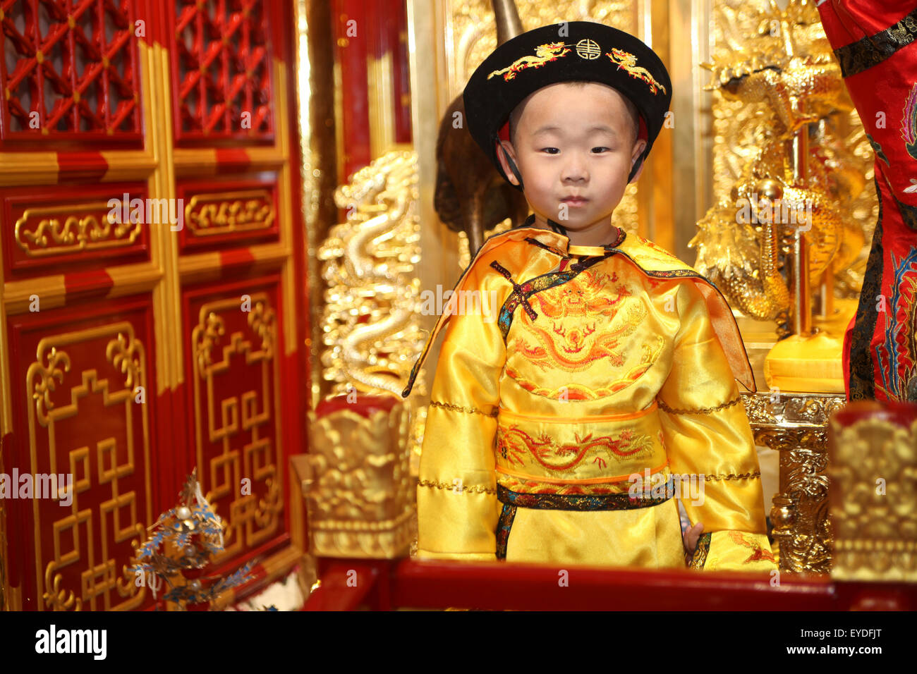 LITTLE EMPEROR. A young Chinese boy enjoys his time in photographers ...