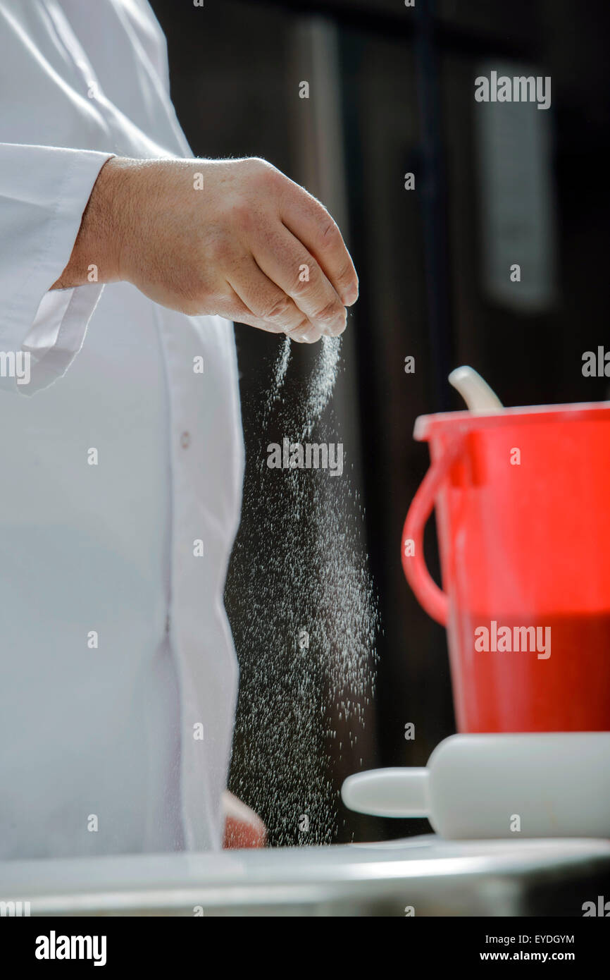Sprinkling salt into mixing bowl Stock Photo - Alamy