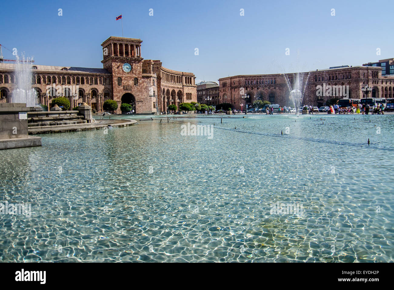 Sunshine illuminating Republic Square in Yerevan with clear water ...