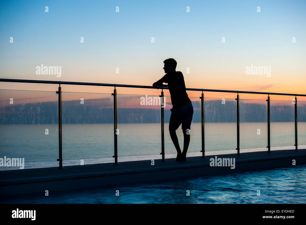 Boy watching sea sunset hi-res stock photography and images - Alamy