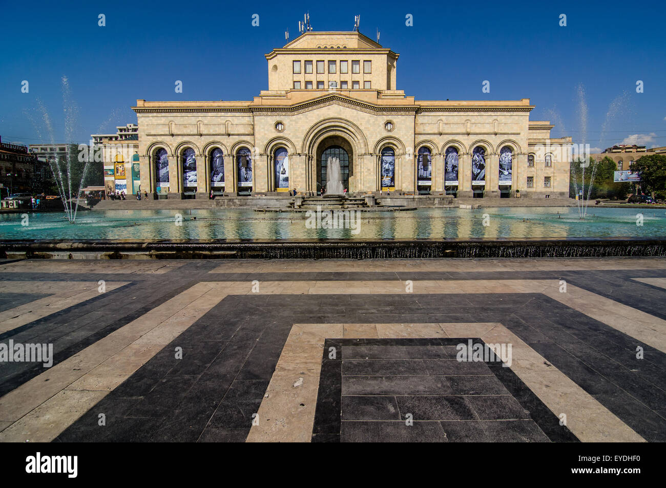 Sunshine illuminating Republic Square in Yerevan with clear water ...
