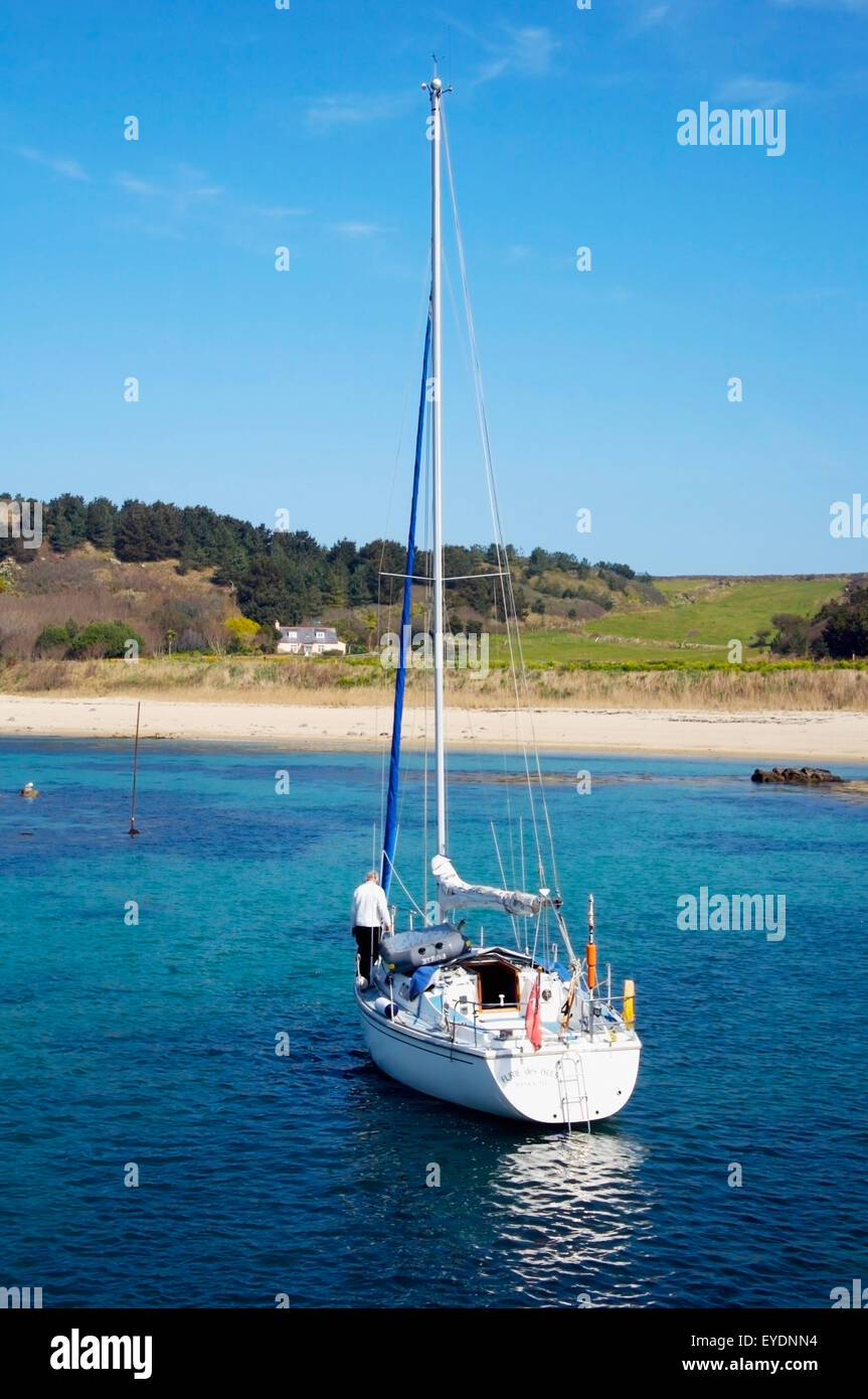 England, Channel Islands, Sailing boat leaving coast; Herm Stock Photo ...