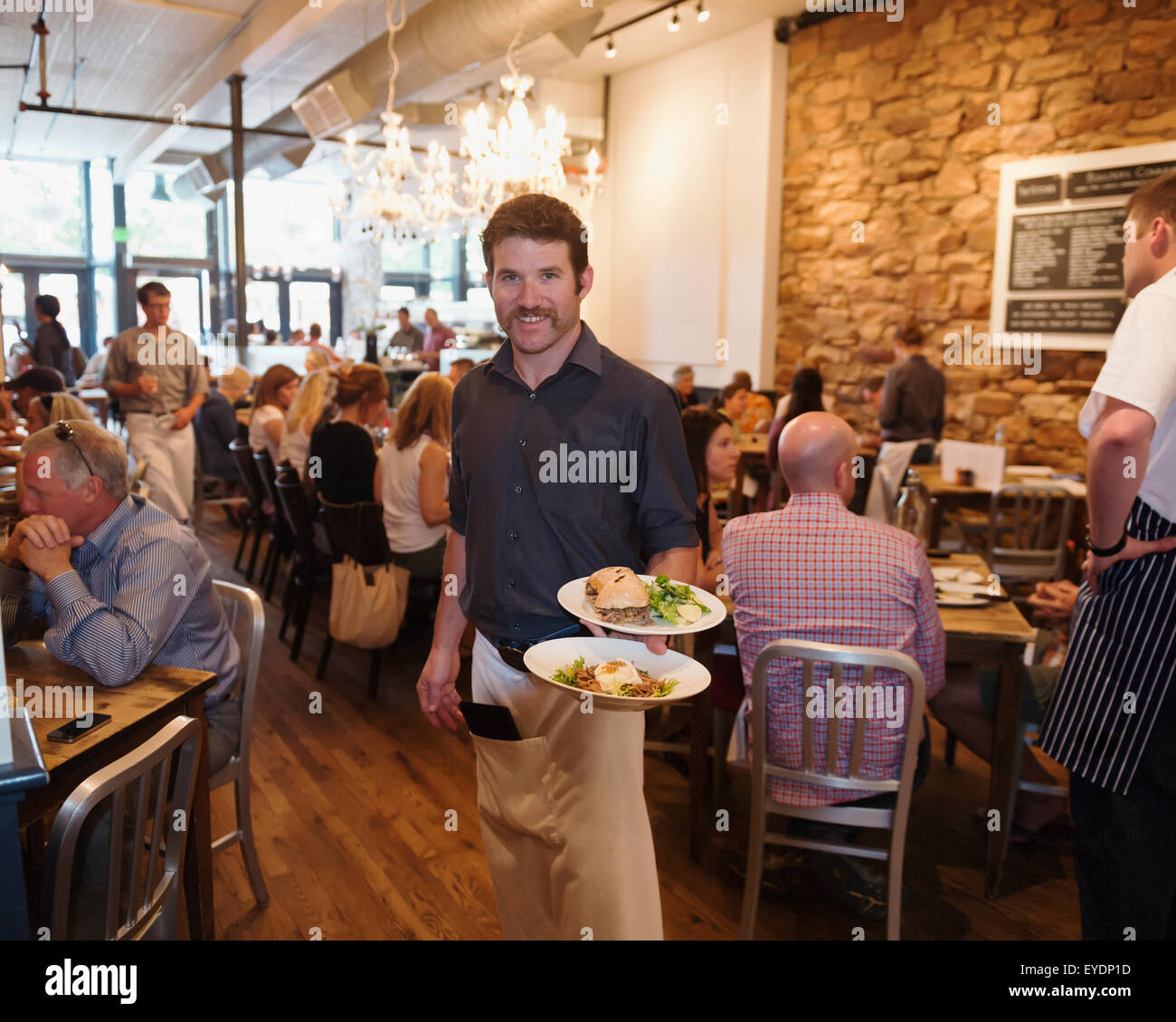 USA, Colorado, Lunchtime waiter service at Kitchen restaurant; Boulder ...
