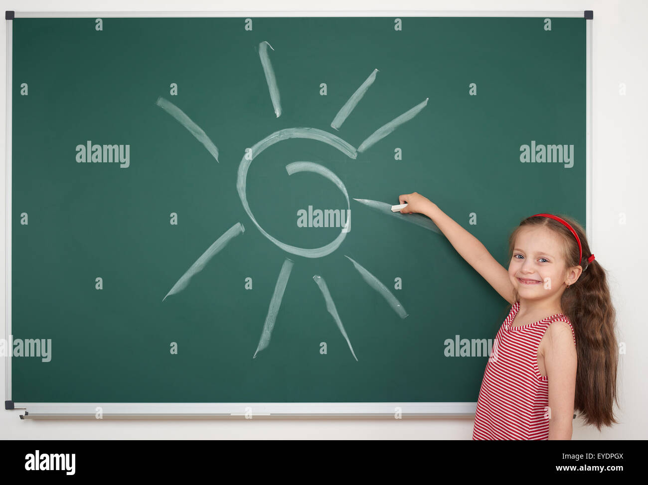 girl drawing sun by white chalk on school board Stock Photo - Alamy