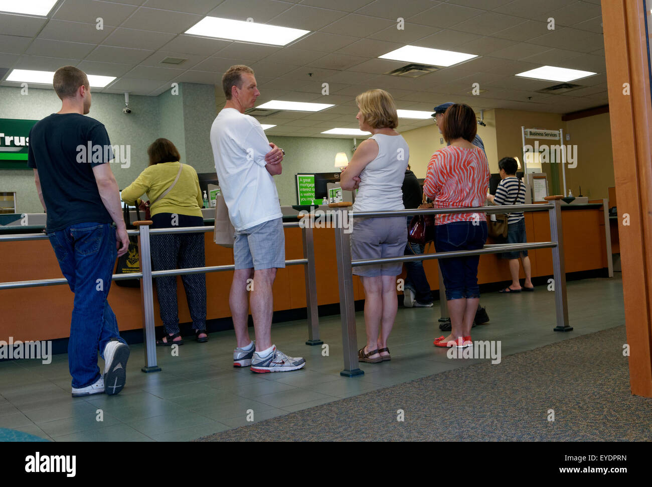 People standing in a bank lineup, Toronto-Dominion Bank, Vancouver ...