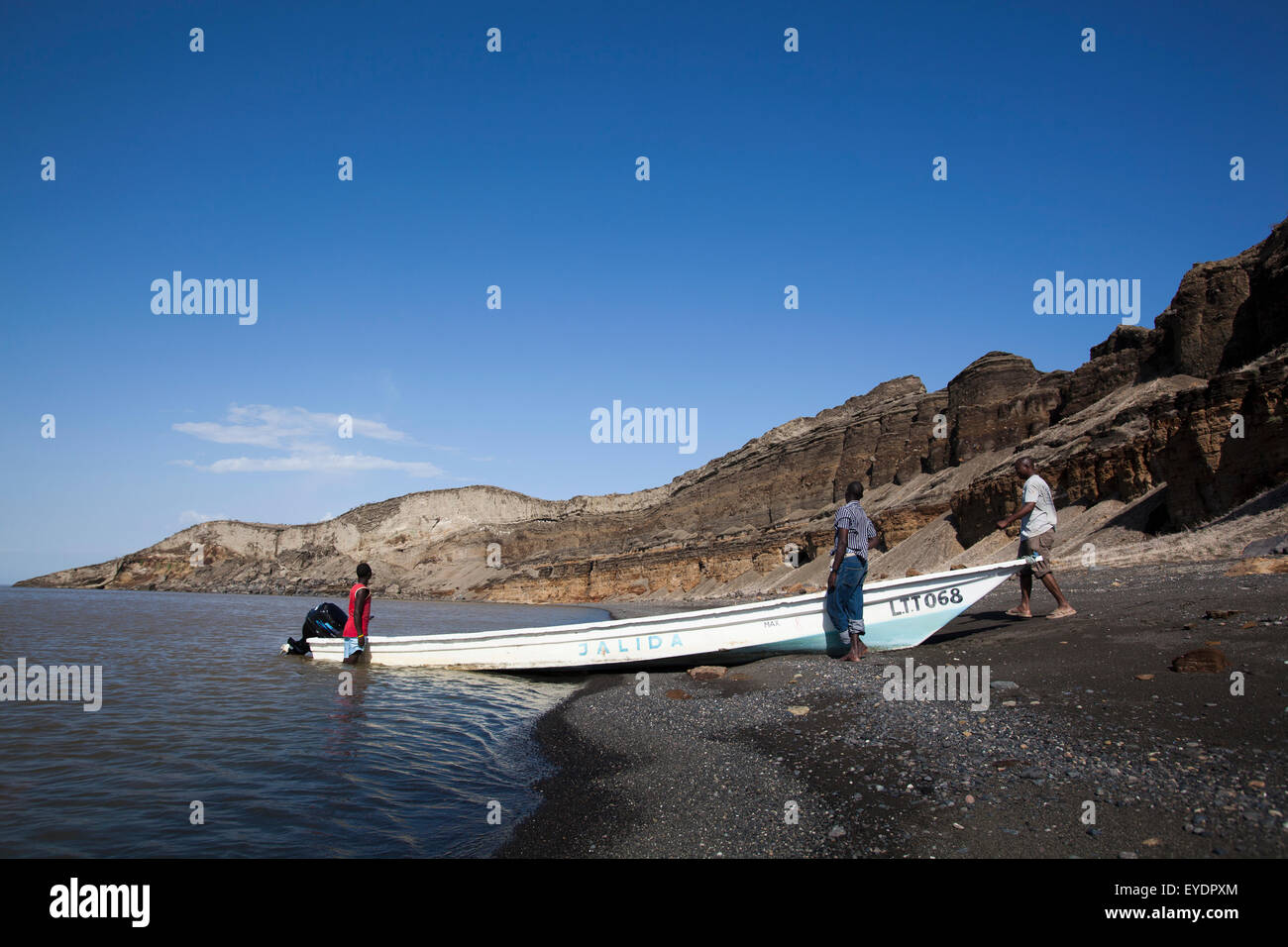 Kenya, Turkana, View of men and fishing boat in Central Island National ...