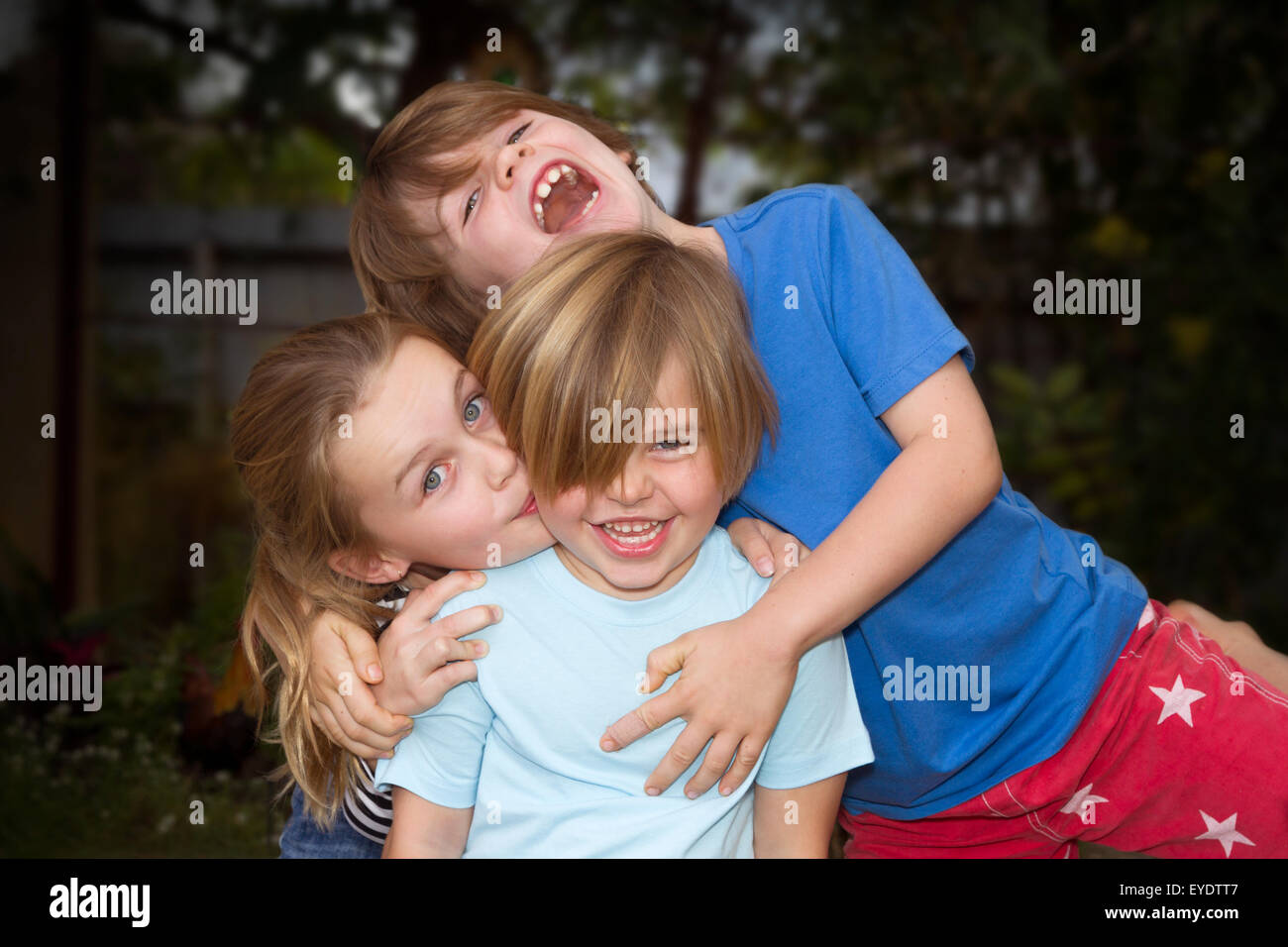 Three siblings playing and having fun Stock Photo - Alamy