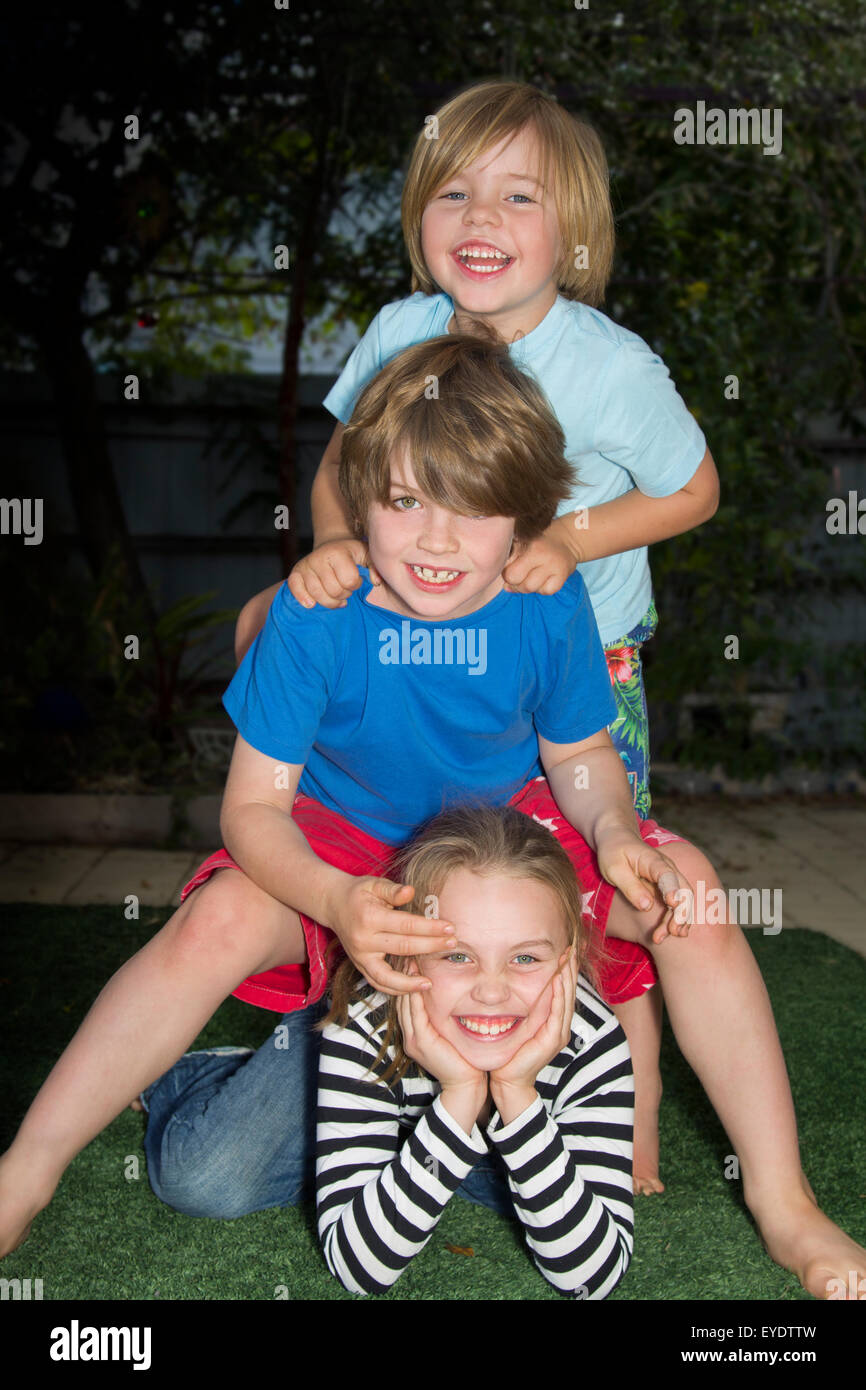 Three siblings playing and having fun Stock Photo - Alamy