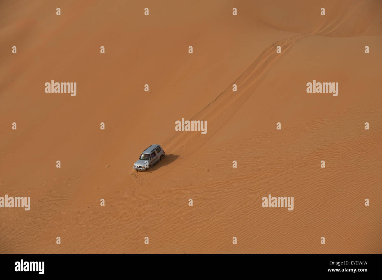 UAE, Abu Dhabi, Four wheel drive going down steep sand dune; Liwa Stock ...