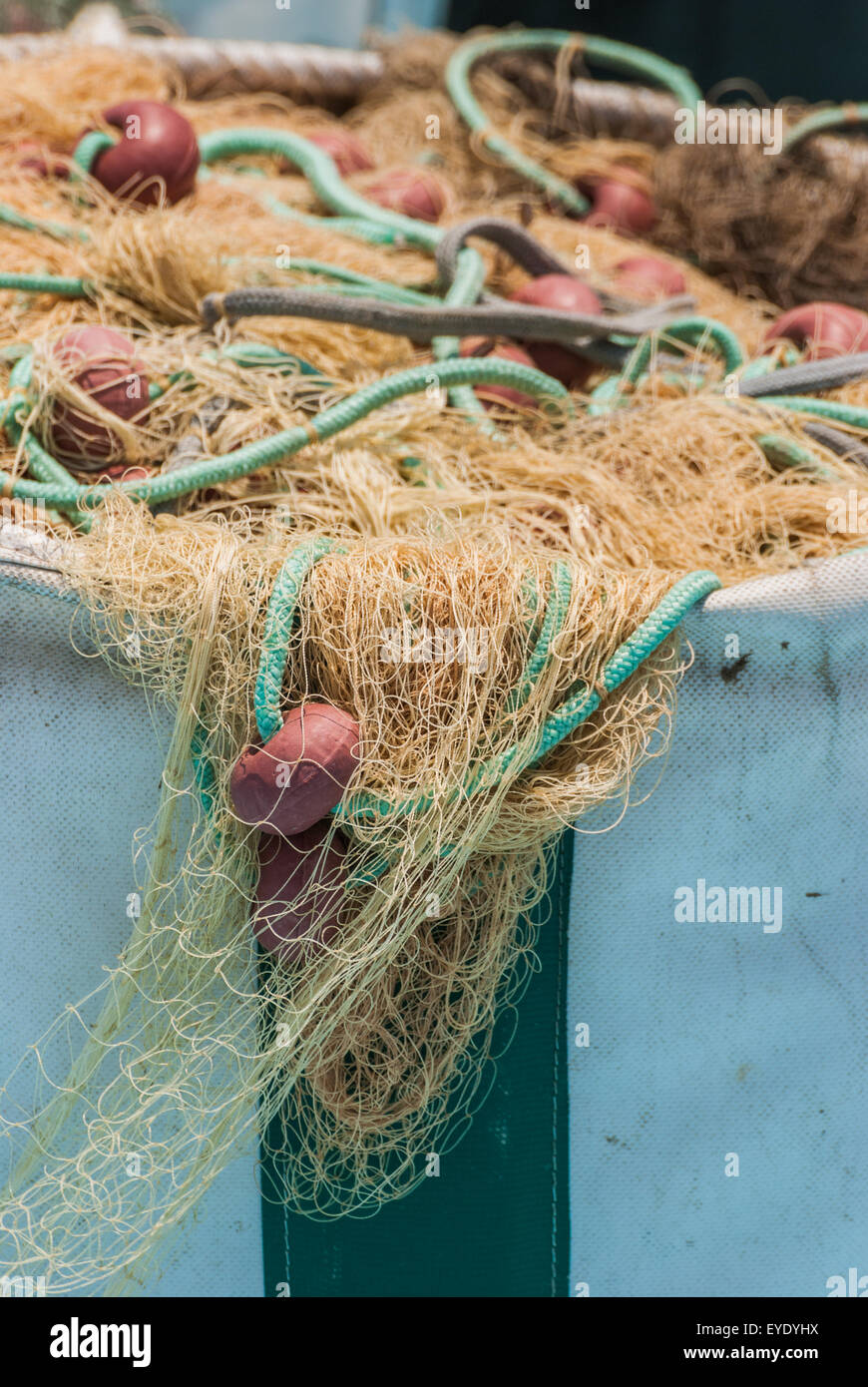Fishing nets with floats in basket closeup. Fishing nets and floats as ...
