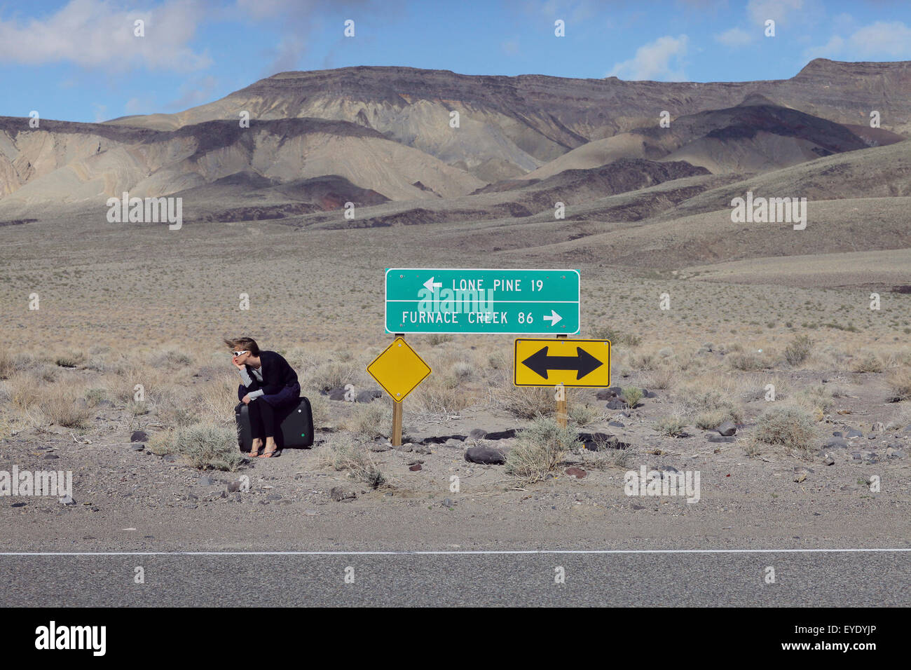 Usa, Route 136 Near Death Valley; California, Young Woman Sitting By ...