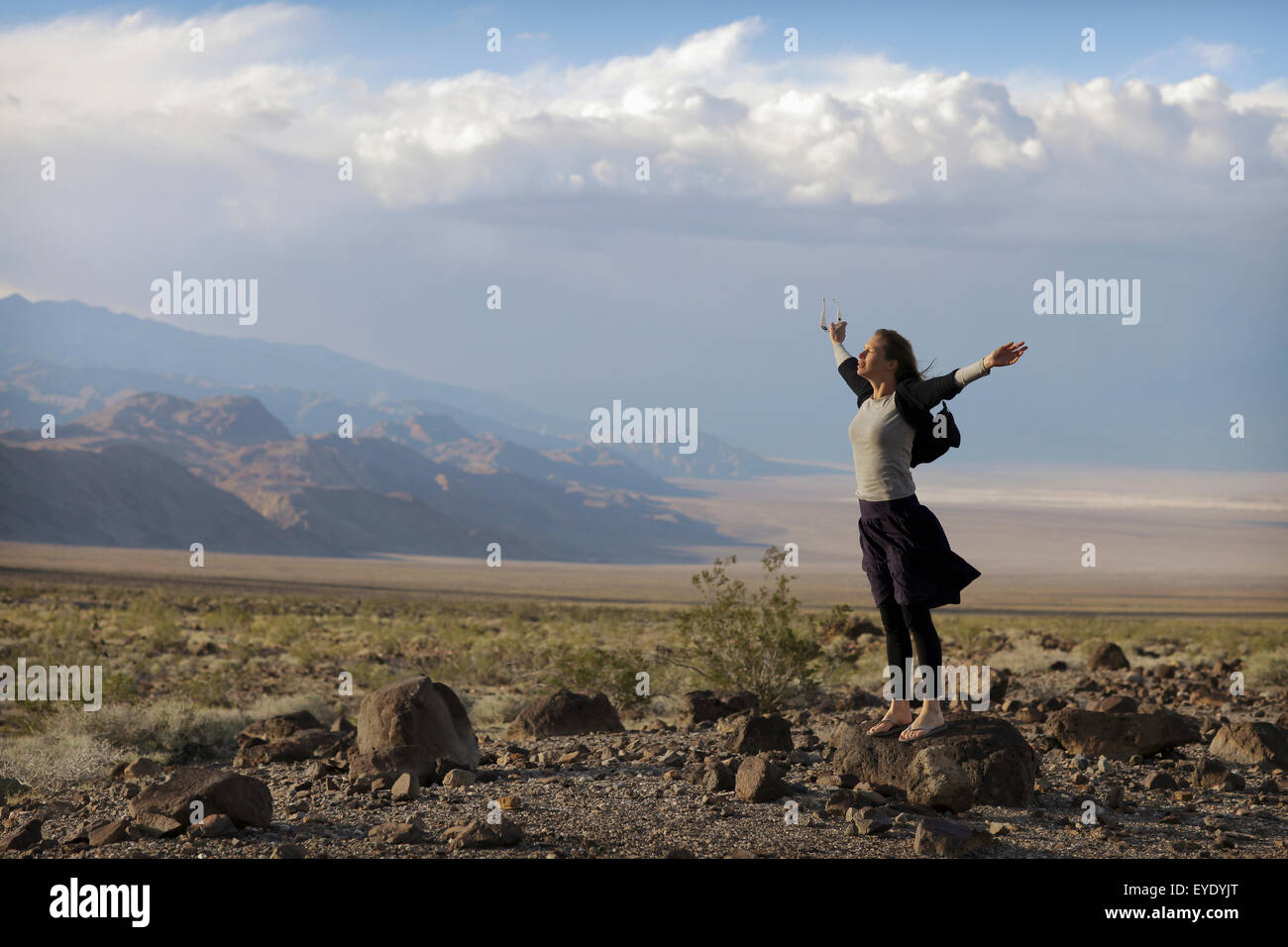 Usa, California, Woman Standing With Arms Raised; Death Valley National ...