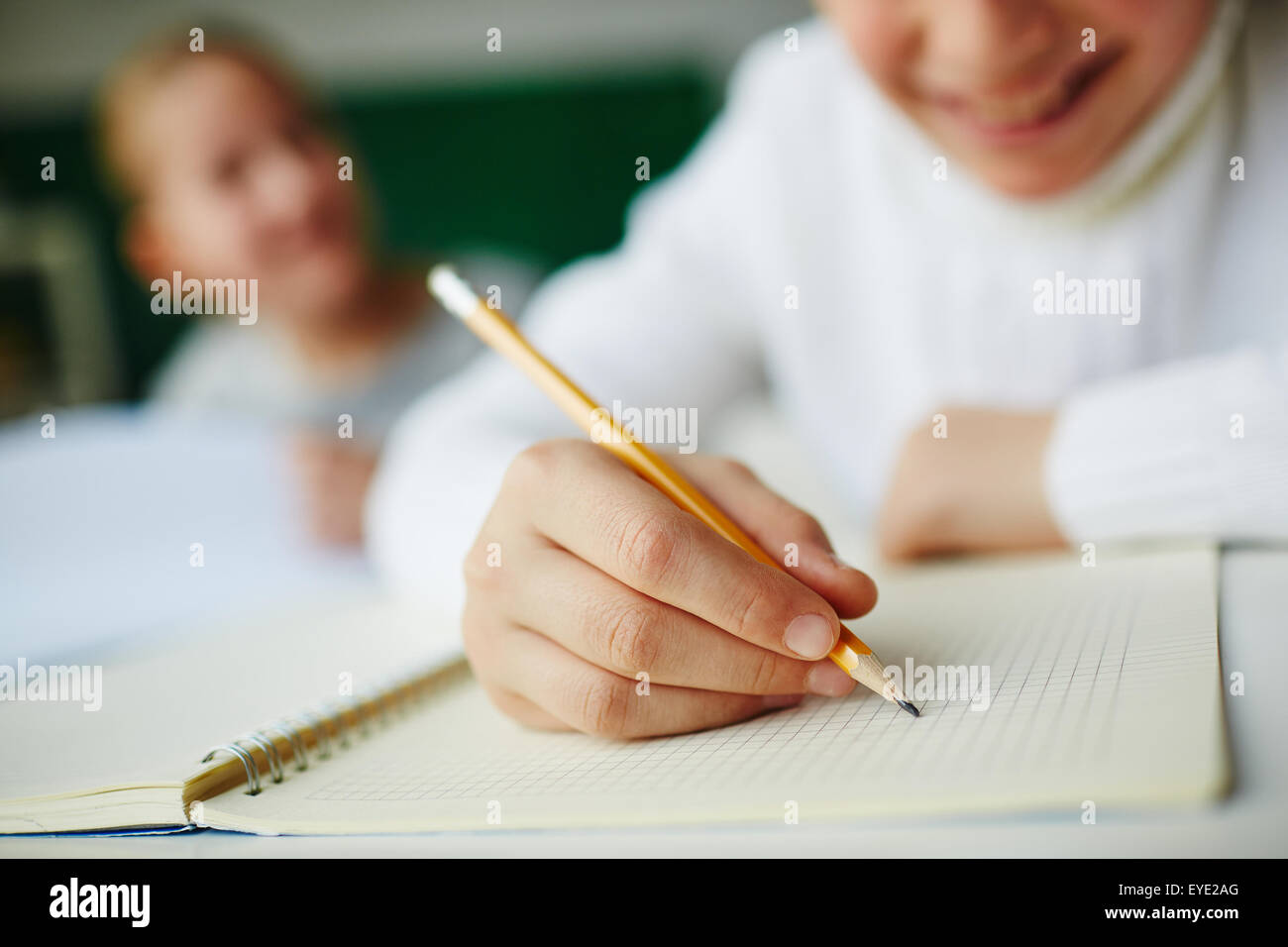 Kid holding pencil and drawing in notepad Stock Photo - Alamy