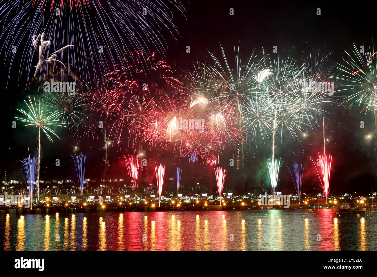 Beautiful colorful fireworks reflect on sea water Stock Photo - Alamy