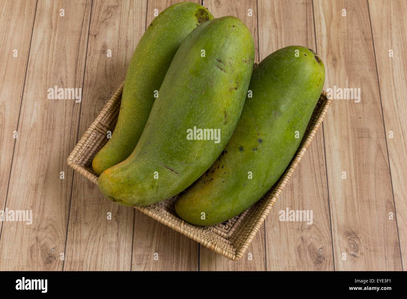Mangoes from Thailand put in a basket on wood background Stock Photo ...