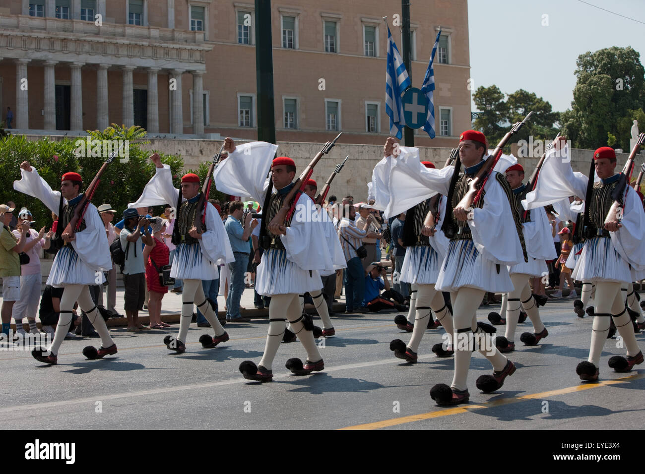 Marching Evzones after the end of a ceremony & tourist crowds watching ...