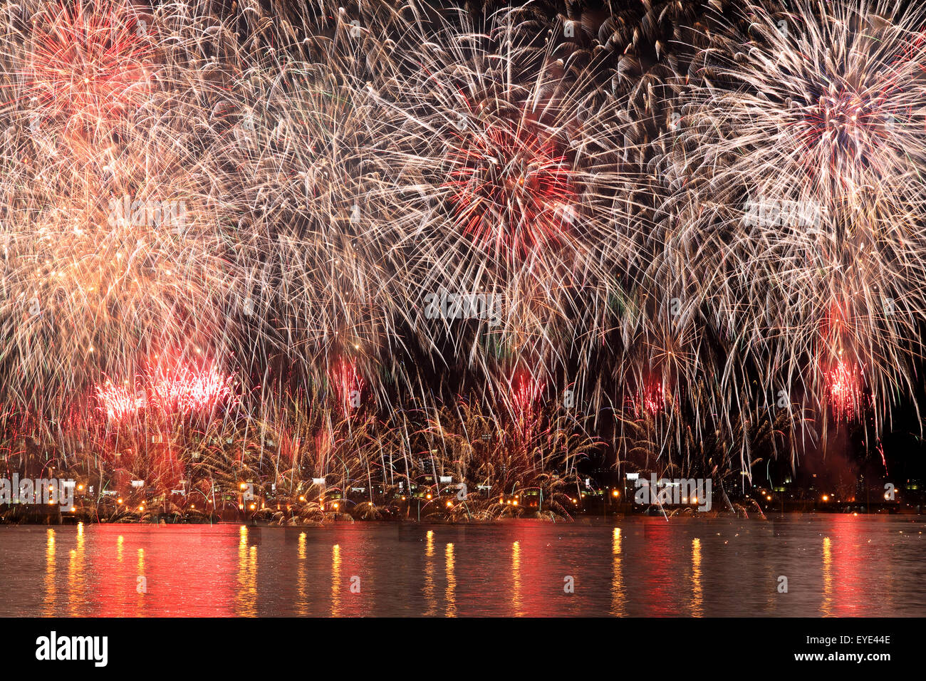 Beautiful colorful fireworks reflect on sea water Stock Photo - Alamy
