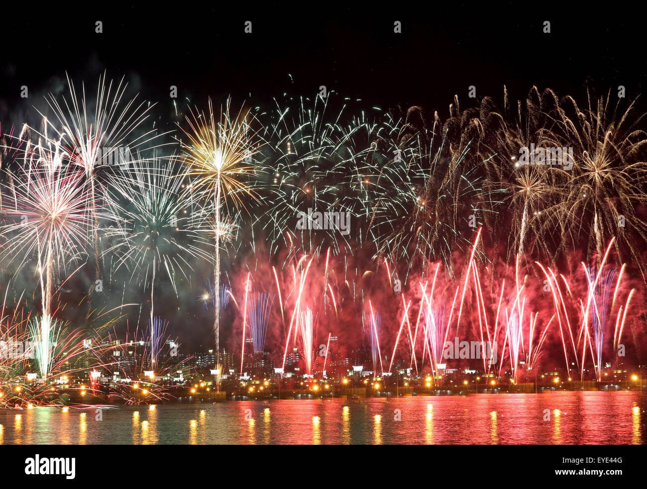 Beautiful colorful fireworks reflect on sea water Stock Photo - Alamy